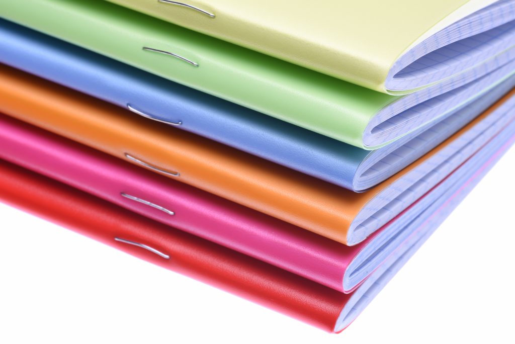 Stack of exercise books isolated on white background - RP Printers